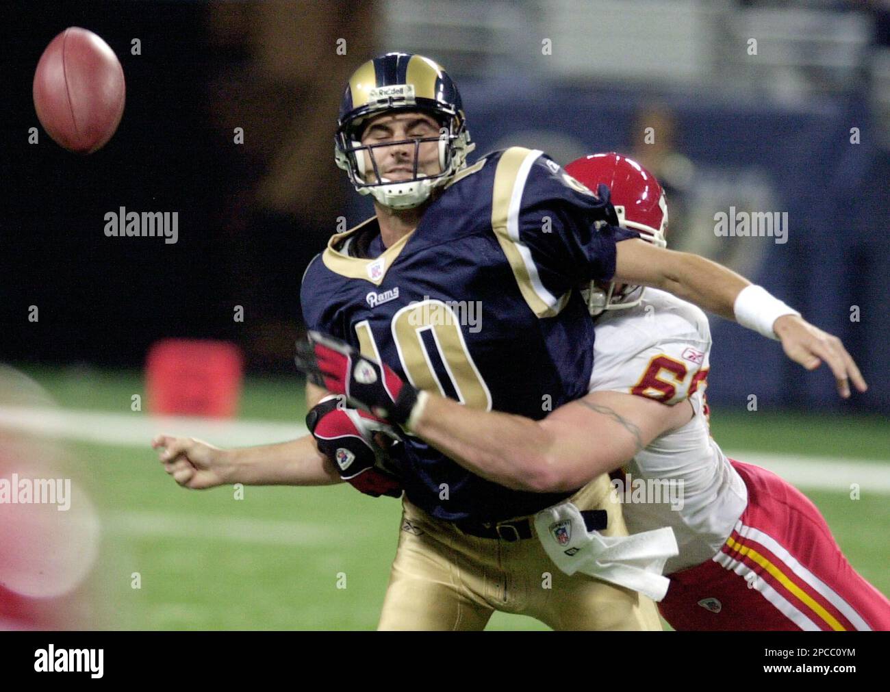 St. Louis Rams' quarterback Mark Bulger fumbles after being hit by ...