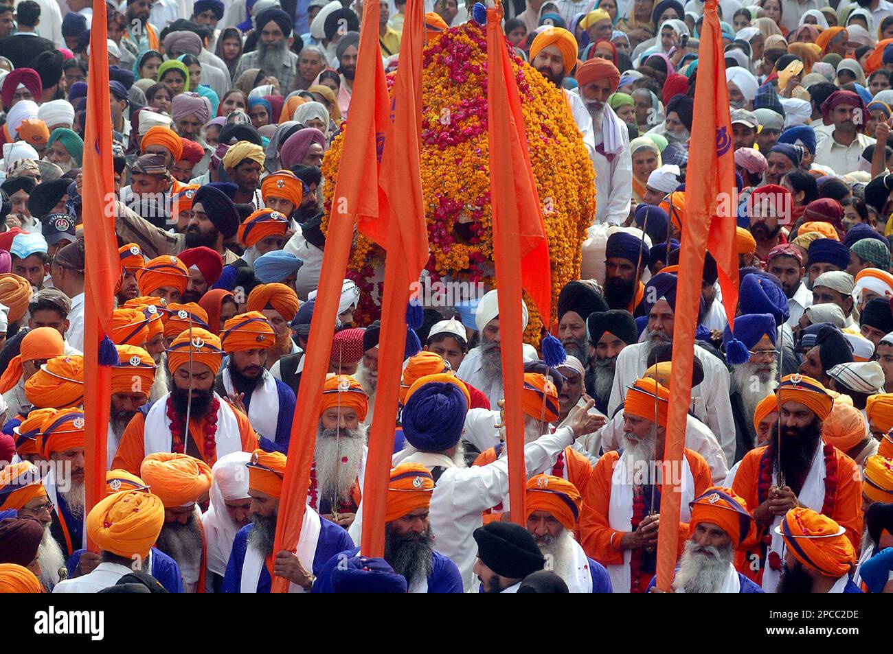 Sikh pilgrims bring Palkee, or a bunch of flowers, to pay homage to ...