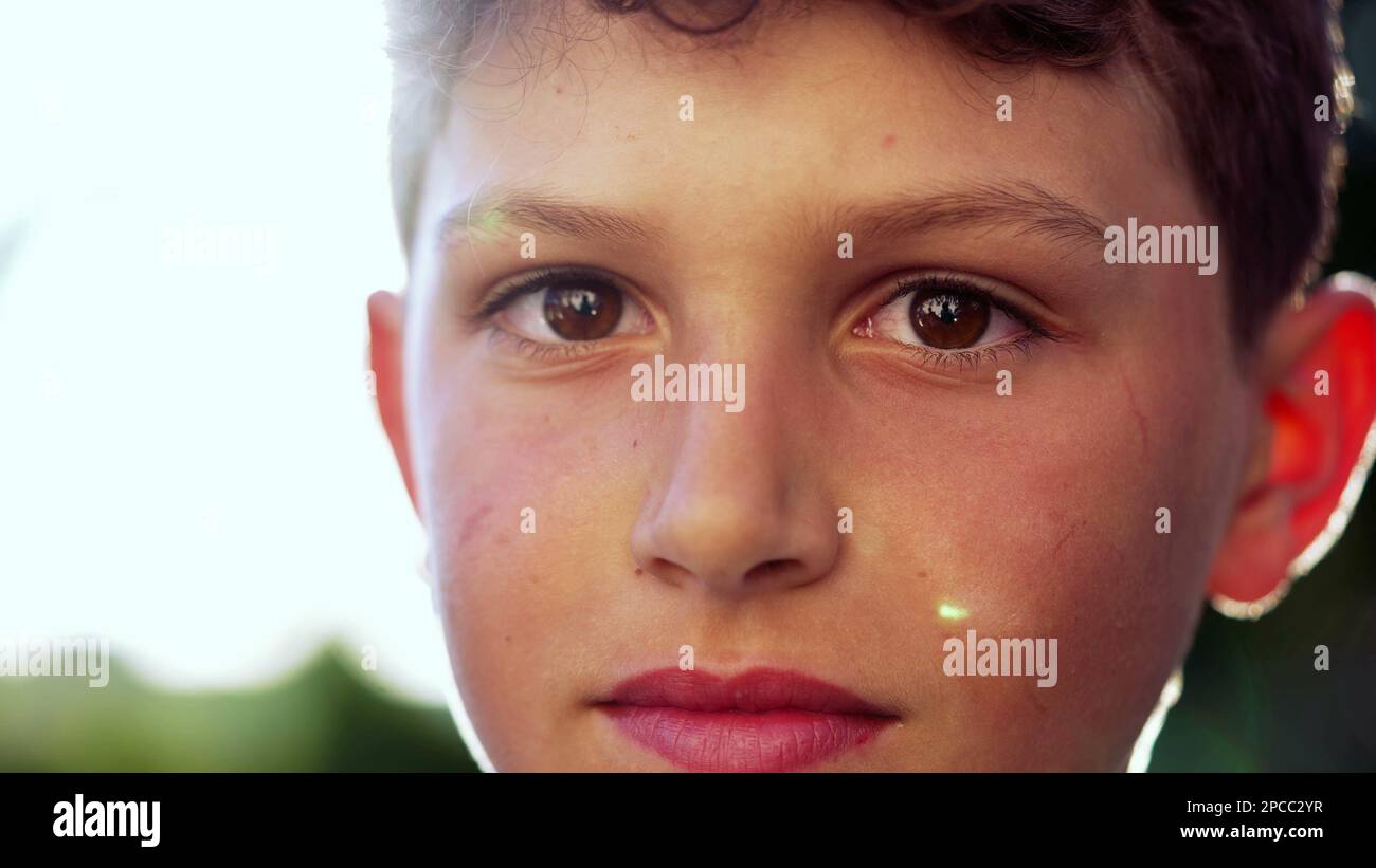 Portrait of a preteen male child close up face standing outside in ...