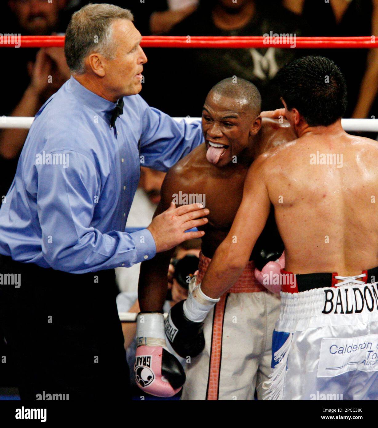 Referee Jay Nady, left, breaks up Floyd Mayweather Jr., center, and Carlos Baldomir, of ...