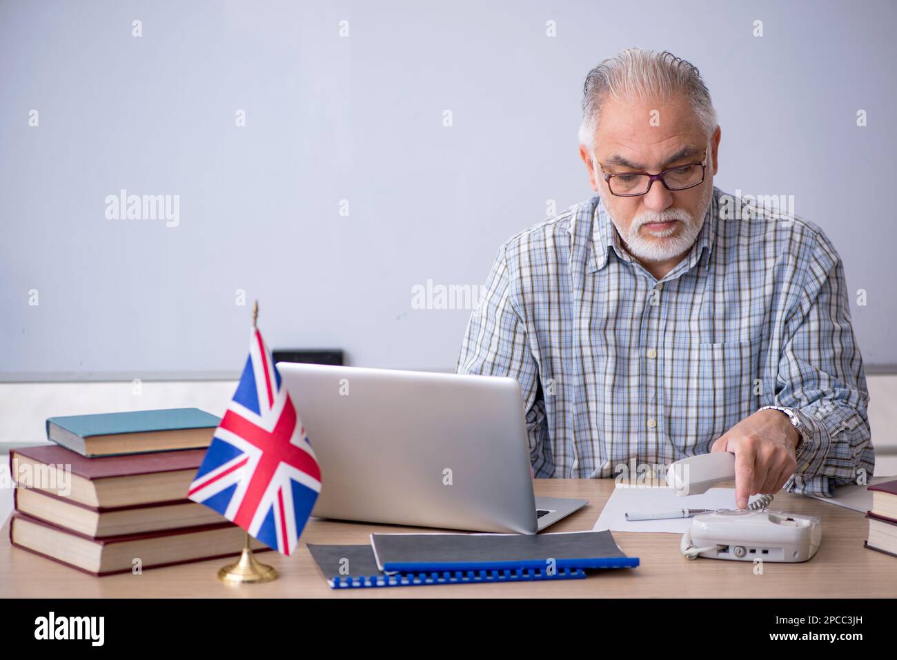 Aged english language teacher in the classroom Stock Photo - Alamy
