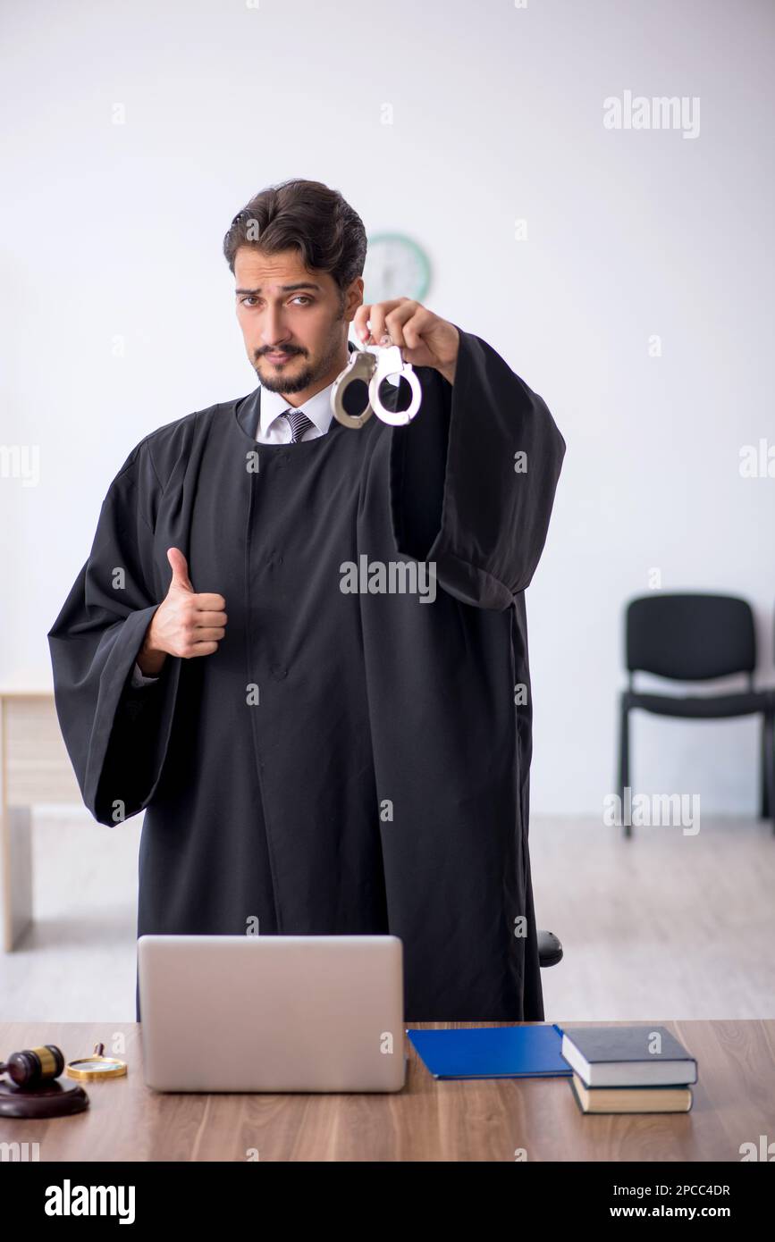 Young judge working in the courthouse Stock Photo - Alamy