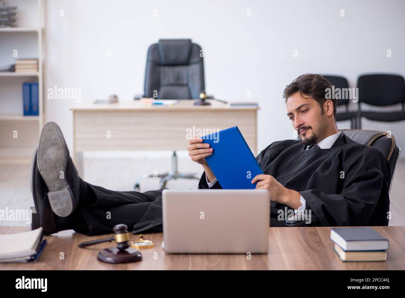 Young judge working in the courthouse Stock Photo - Alamy