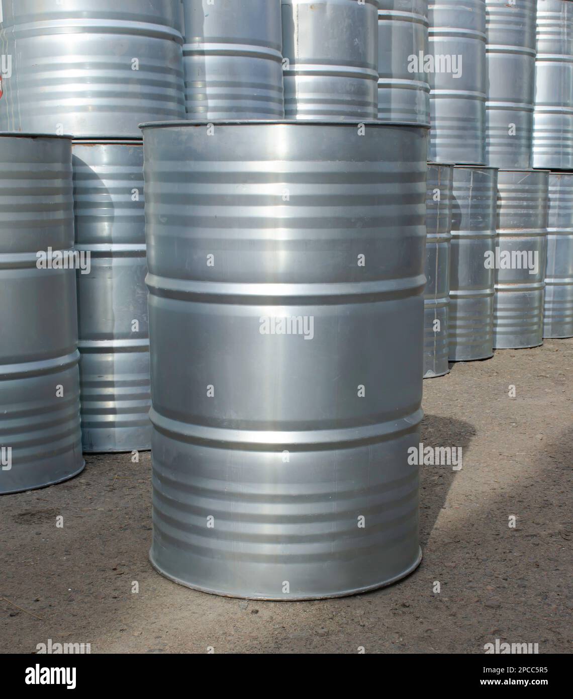 metal barrels for petroleum products, one in the front, and many ...