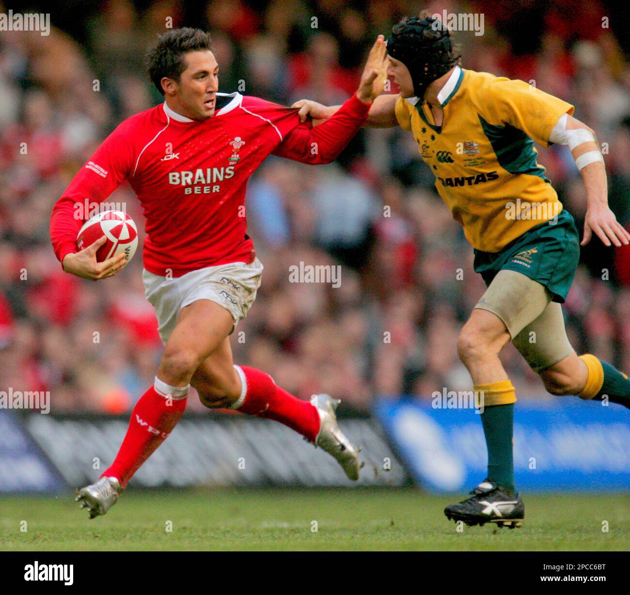 Wales' Gavin Henson, left, attempts to hand off Australia's Clyde ...