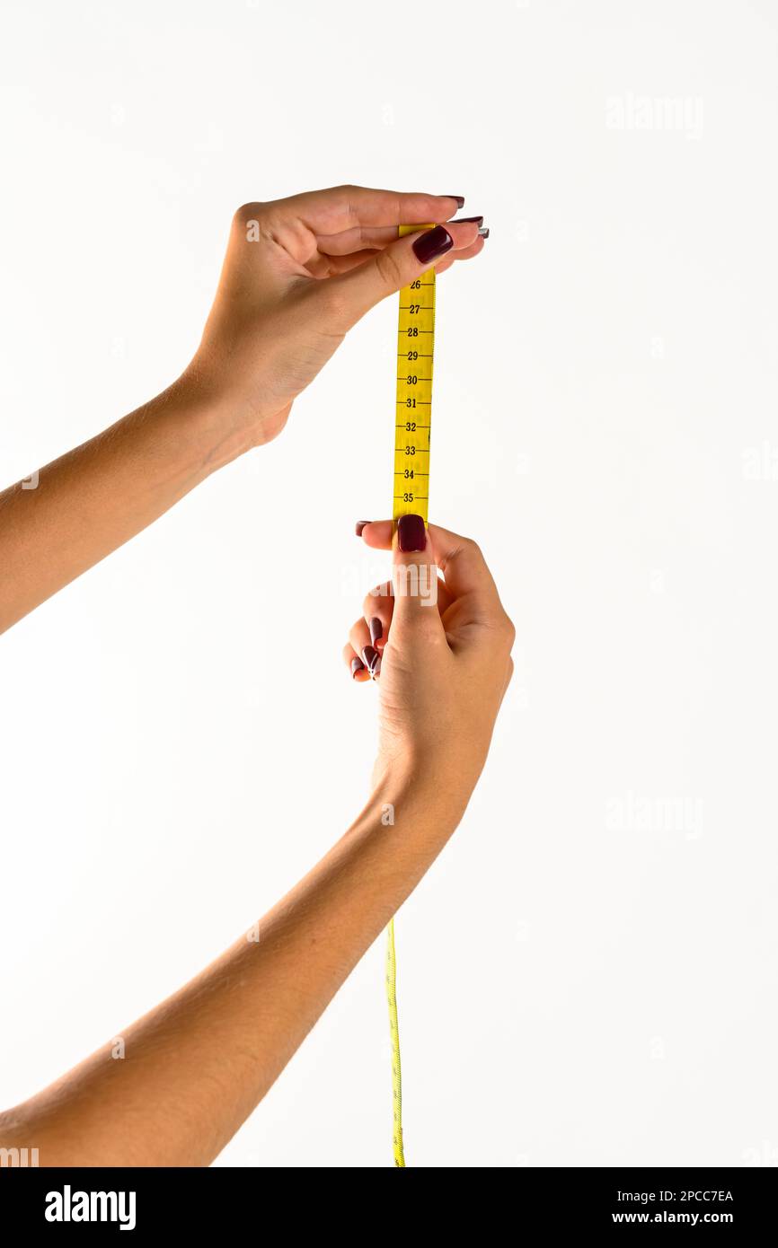 hands of a young woman holding a tape measure, white background Stock ...