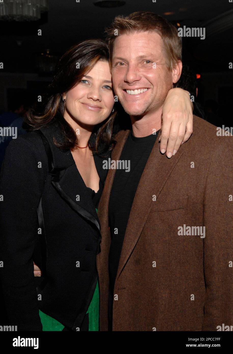 Actor Doug Savant, right, and actress Daphne Zuniga, left, attend the ...