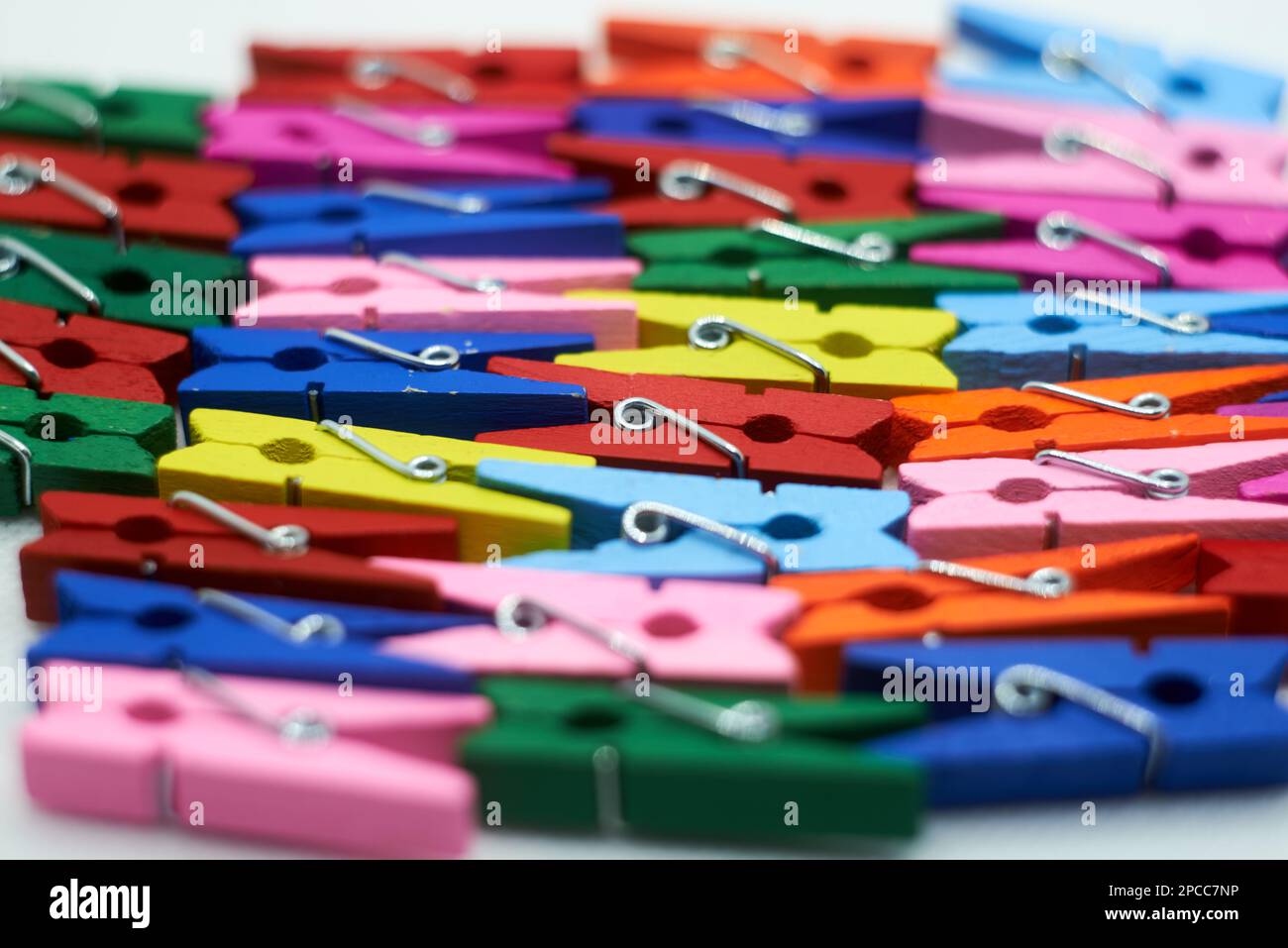 Folded multi-colored clothespins on the table Stock Photo - Alamy