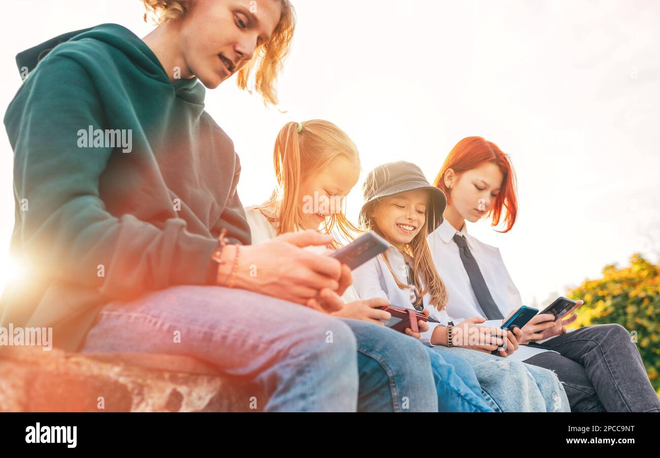 Teenager boy and a sister girls kids sitting and browsing their ...