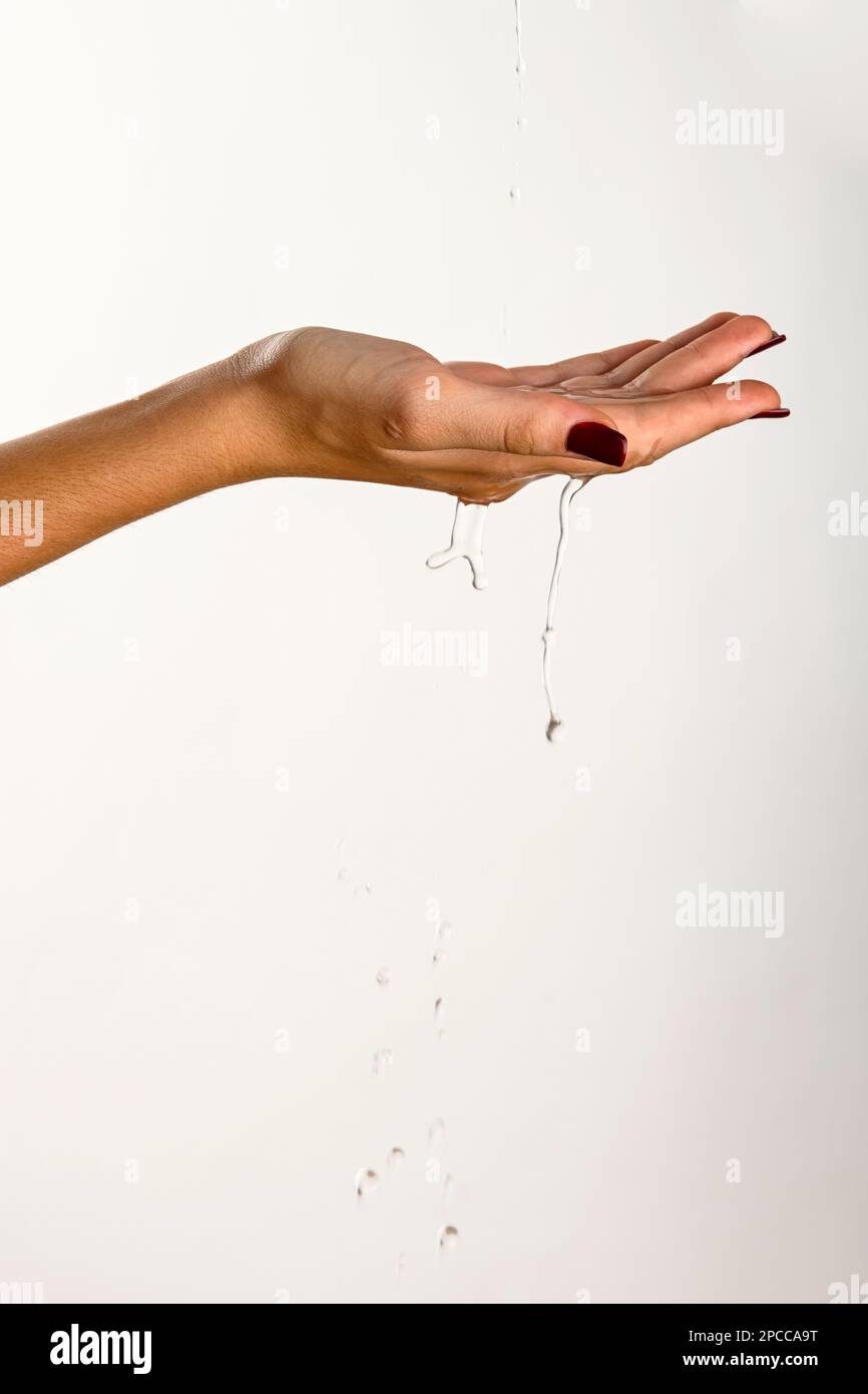 hands of a young woman dripping clear water, white background Stock ...