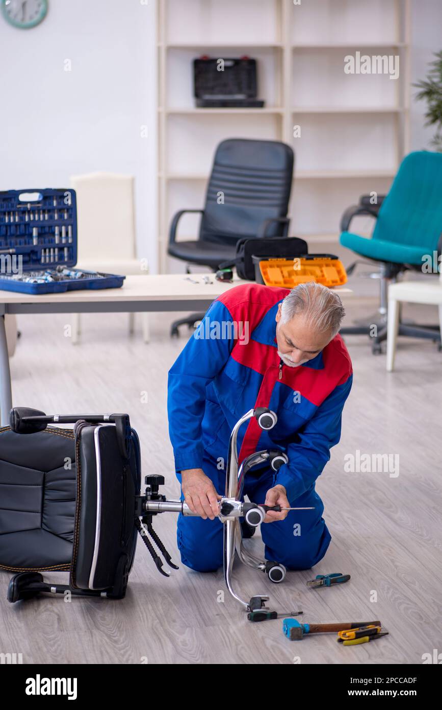 Male repairman repairing office chair hi-res stock photography and ...