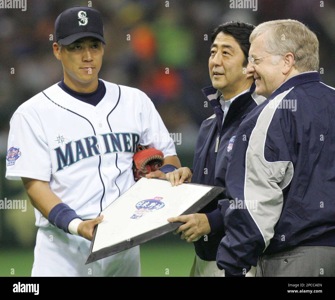 Japanese Prime Minister Shinzo Abe, center, holds a memorial homebase ...