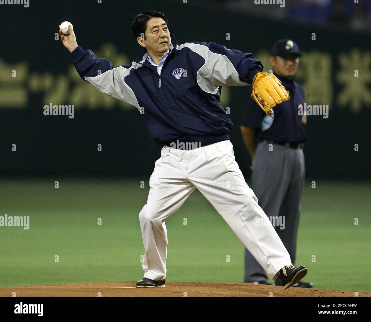 Japan's Prime Minister Shinzo Abe throws out the ceremonial first pitch ...