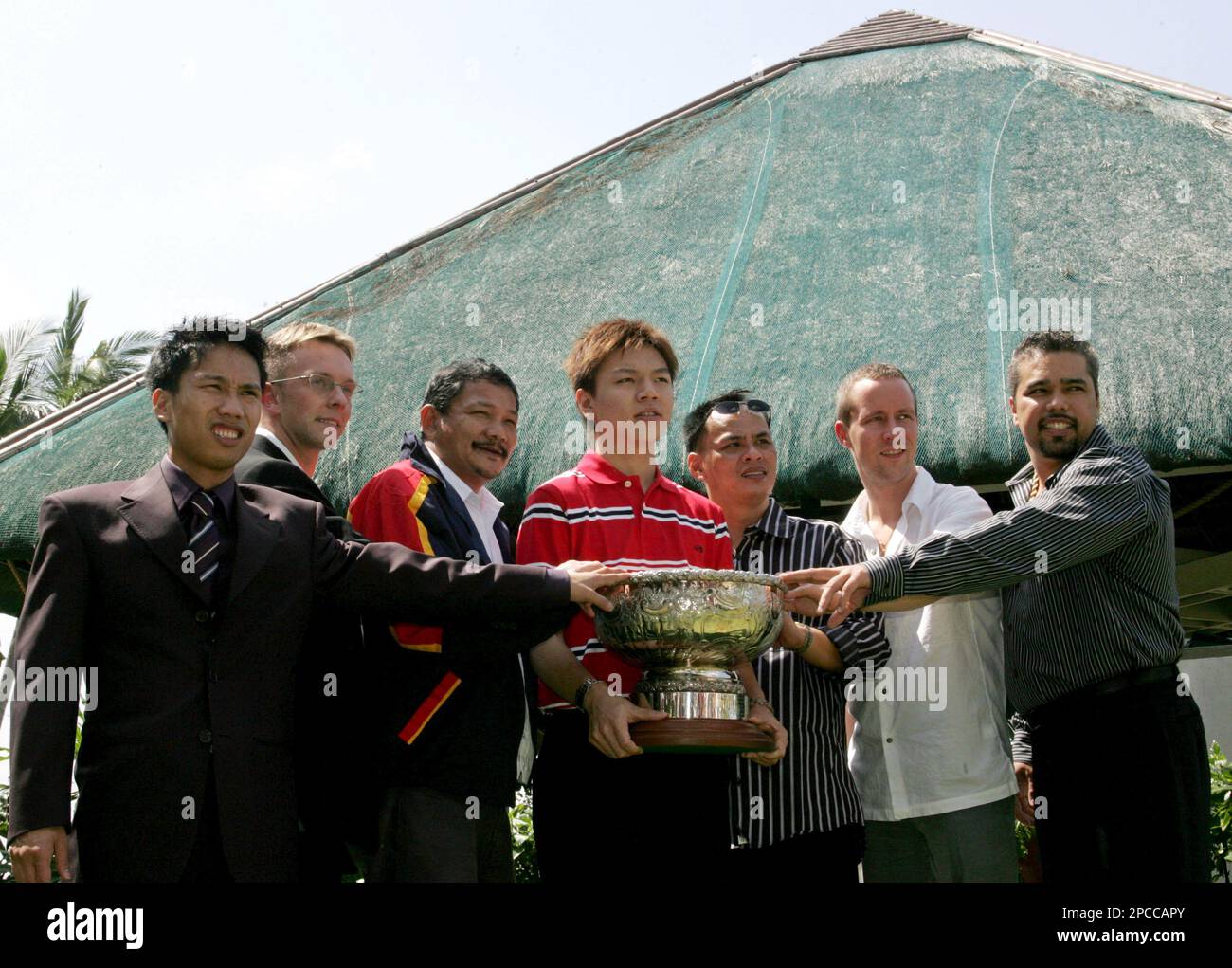 The world's top pool players touch the championship trophy during a ...