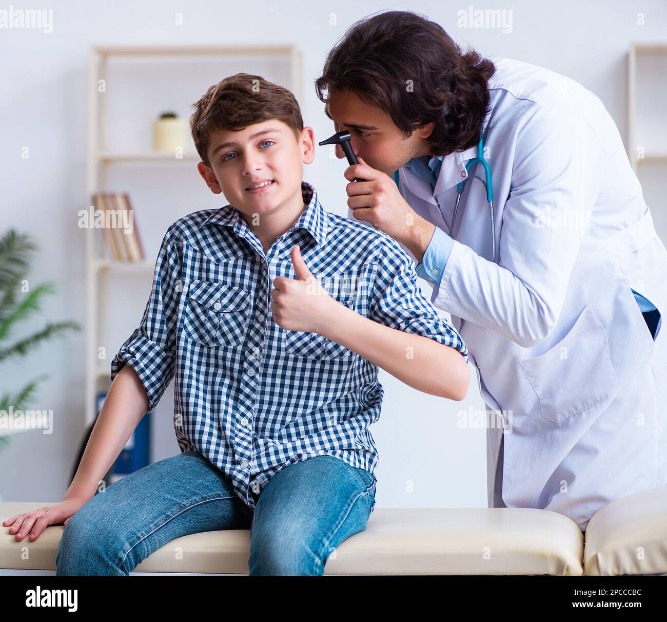 The male otolaryngologist examining boy's ear Stock Photo - Alamy