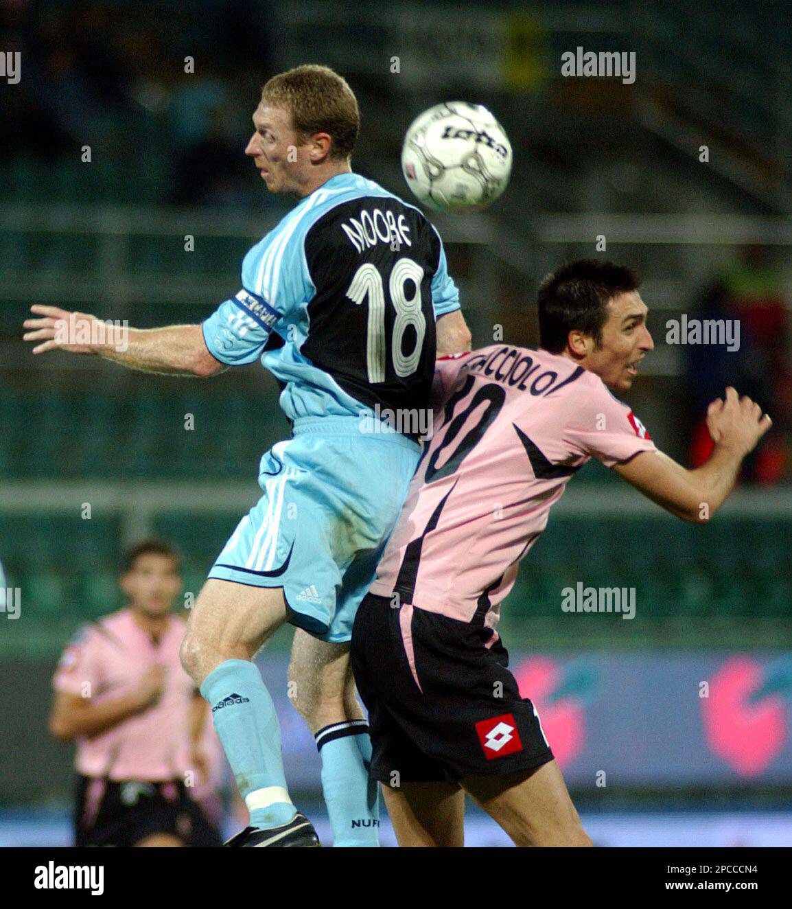 Newcastle's Craig Moore, left, and Palermo's Andrea Caracciolo compete ...