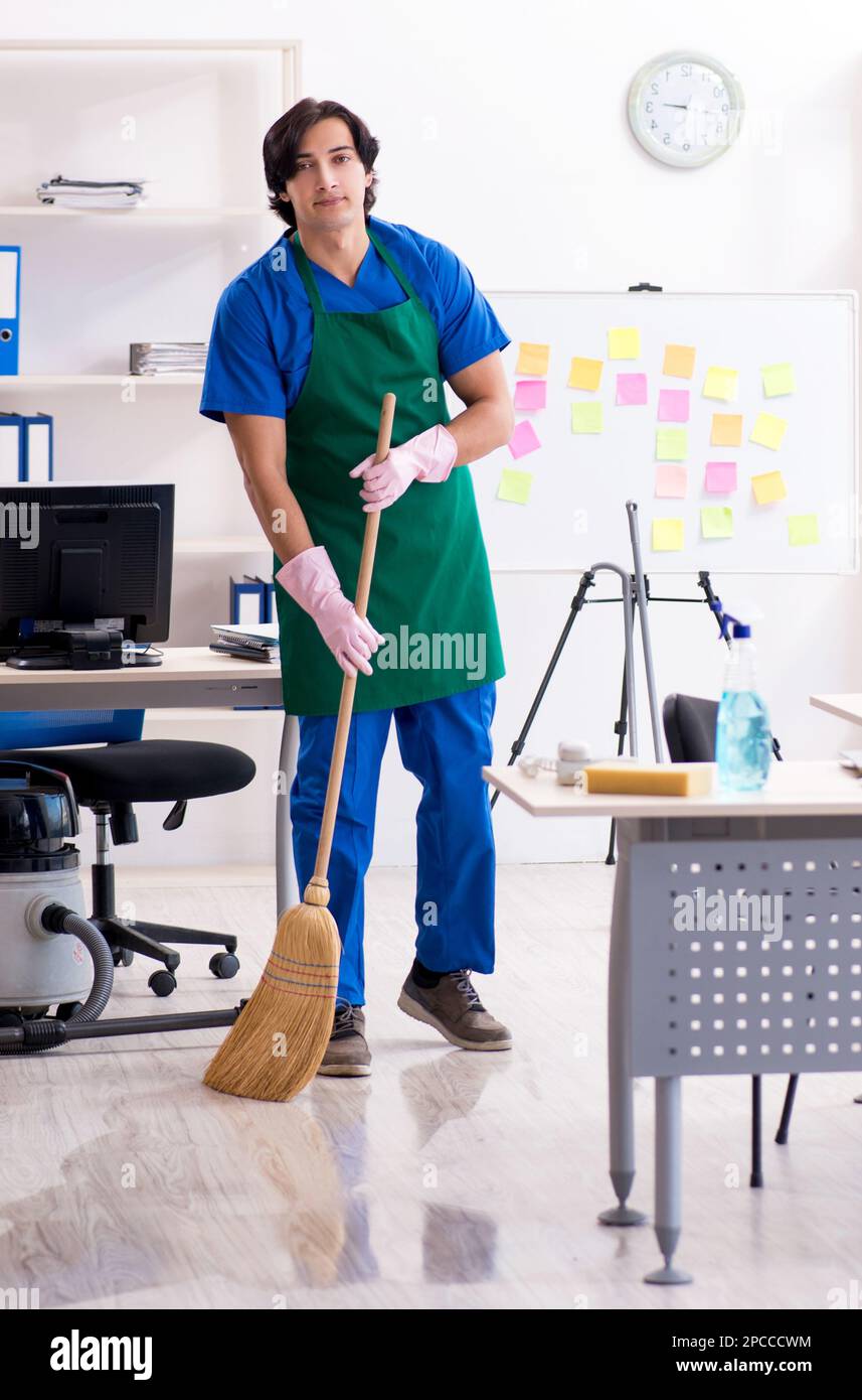 The male handsome professional cleaner working in the office Stock ...