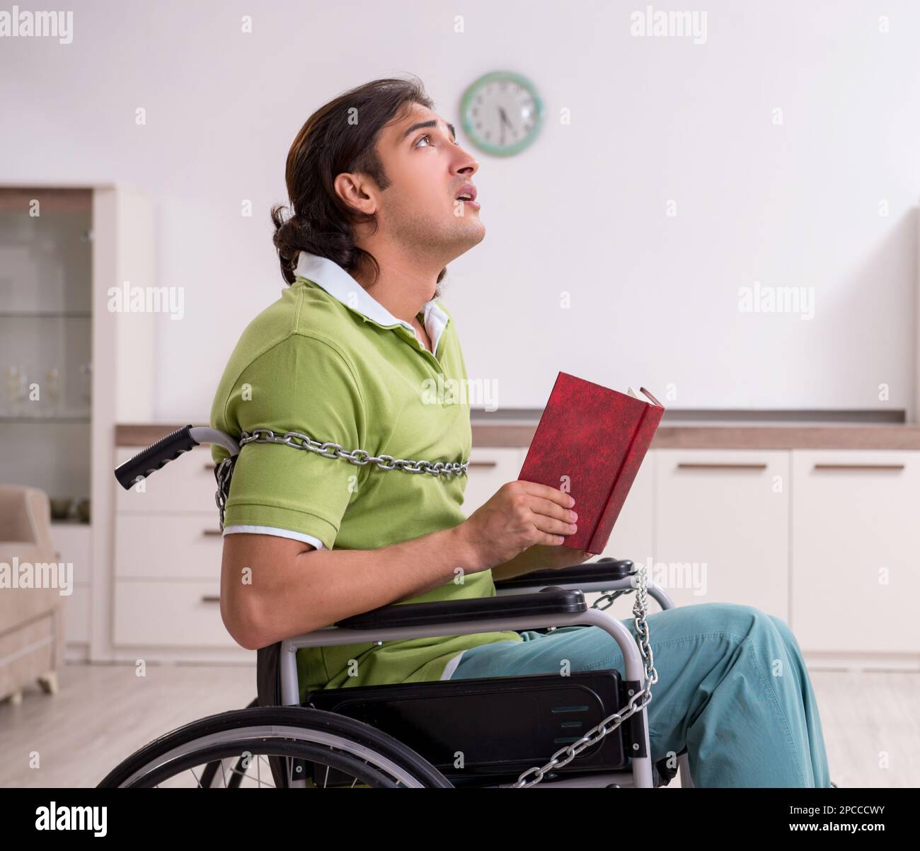 The young male invalid in wheel-chair suffering at home Stock Photo - Alamy