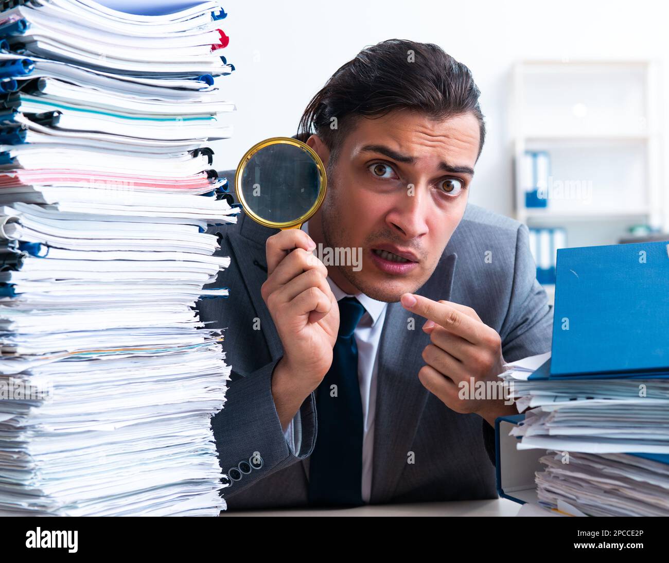 The businessman with heavy paperwork workload Stock Photo - Alamy