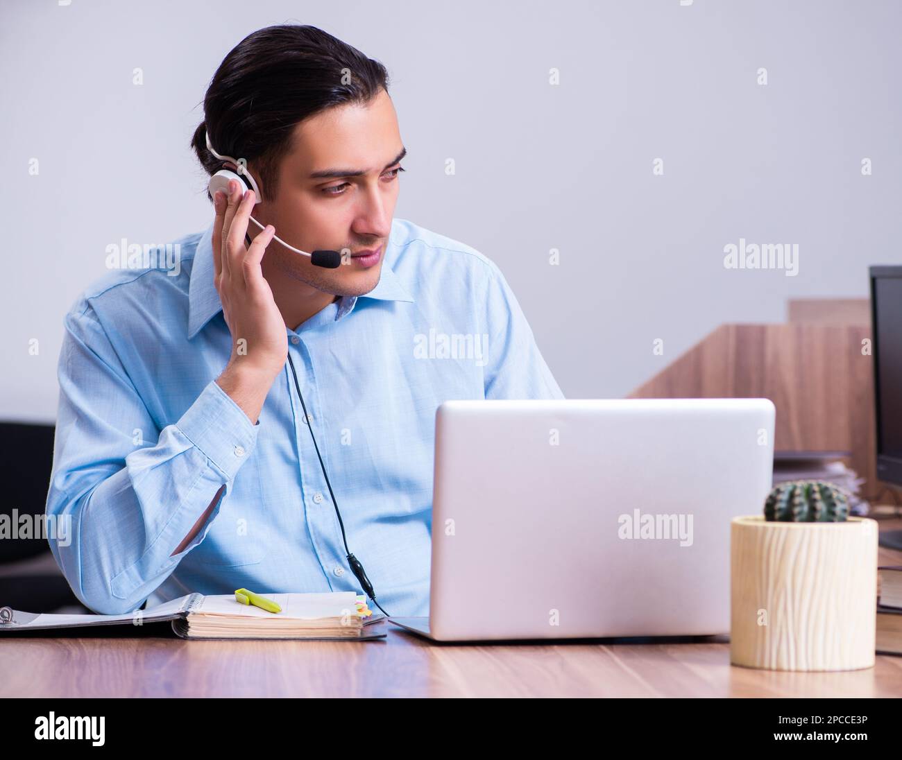 The call center operator working at his desk Stock Photo - Alamy