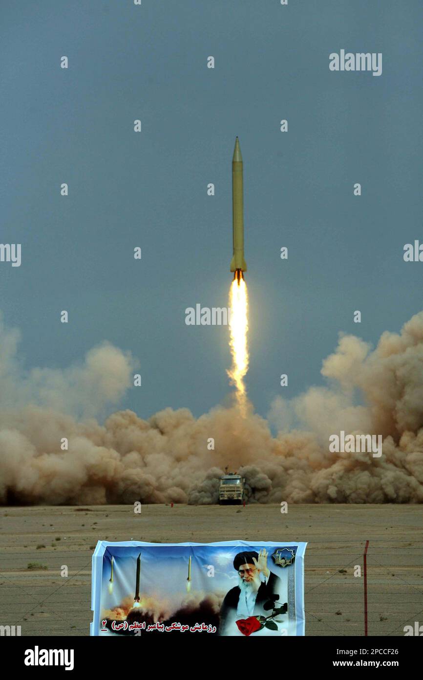 Behind a poster of Iranian supreme leader Ayatollah Ali Khamenei ...