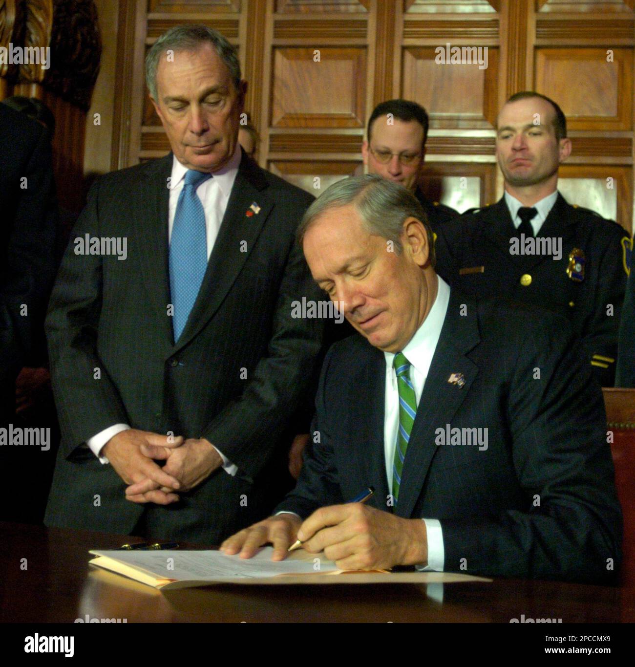 New York Gov. George Pataki, right, signs a bill as New York City Mayor ...