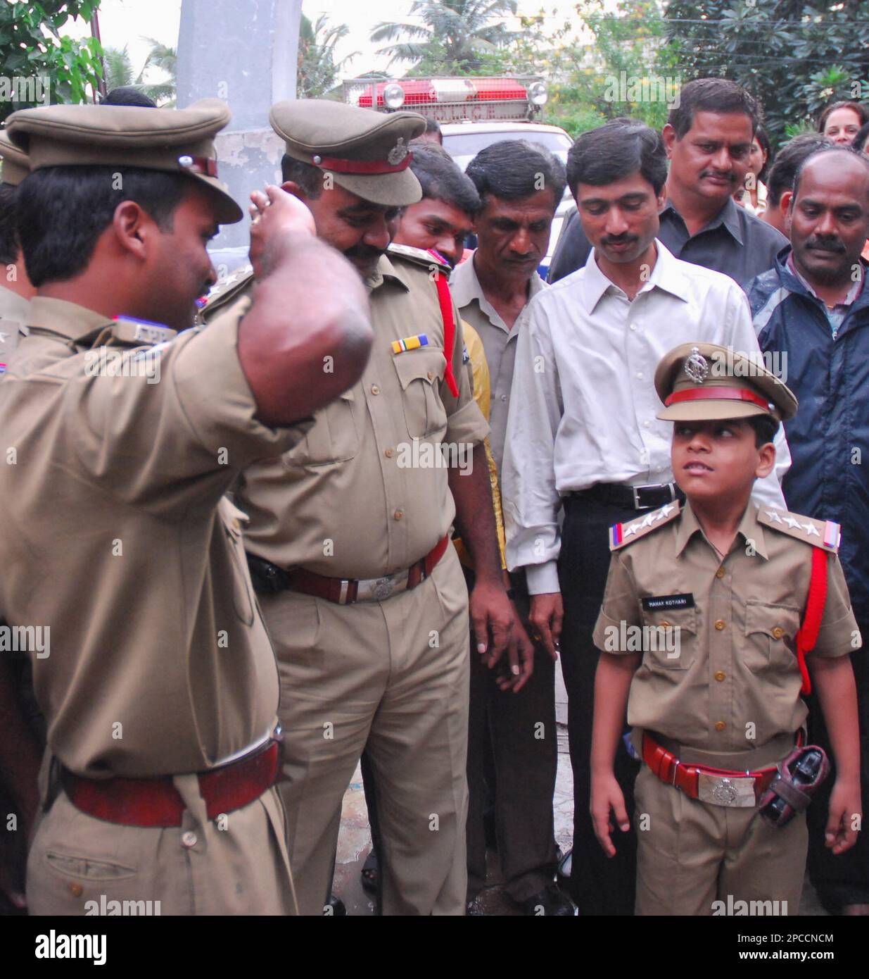 An Indian police officer salutes Mahak Kothari, an 8year old boy who ...