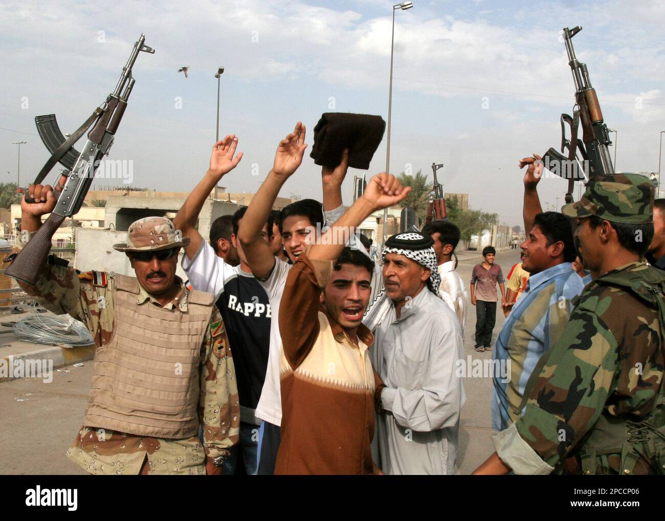 Iraqi soldiers and civilians celebrate after US troops dismantled ...