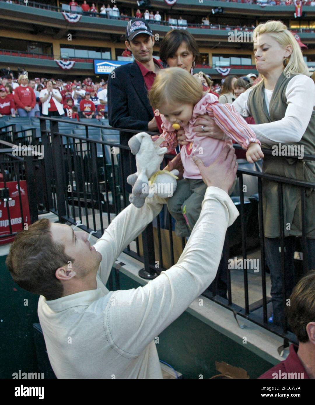 St. Louis Cardinals' Scott Rolen spends a moment with his daughter as ...