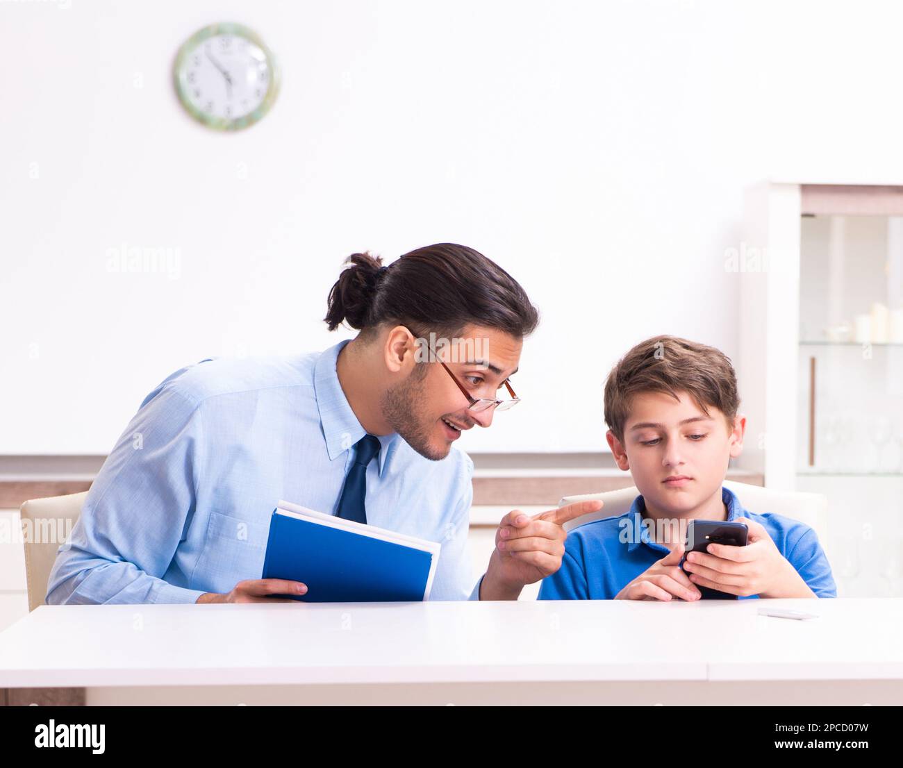 The busy father helping his son to prepare for exam Stock Photo - Alamy