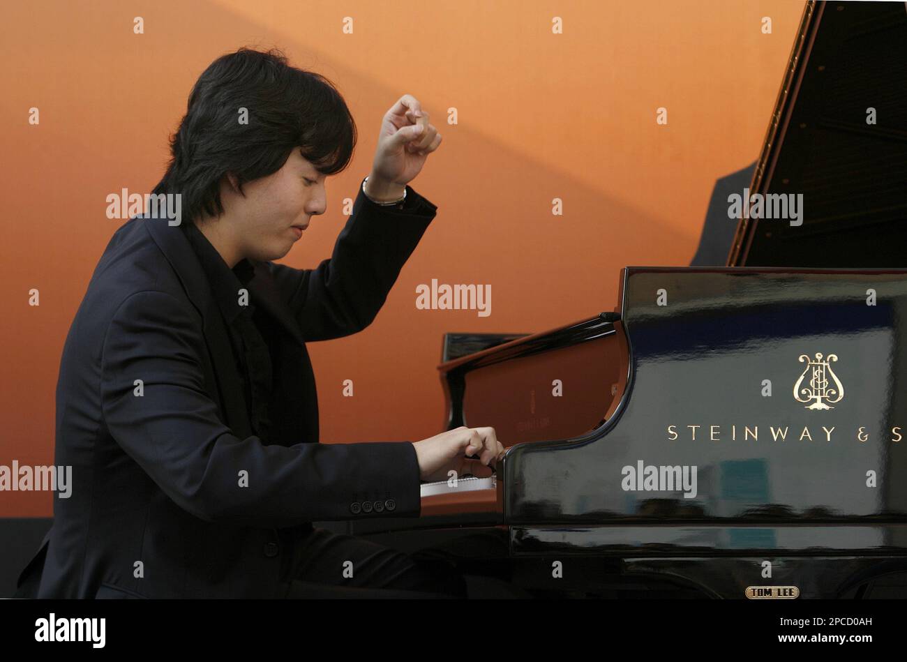 Painist Li Yundi of China performs at a shopping mall in Hong Kong ...