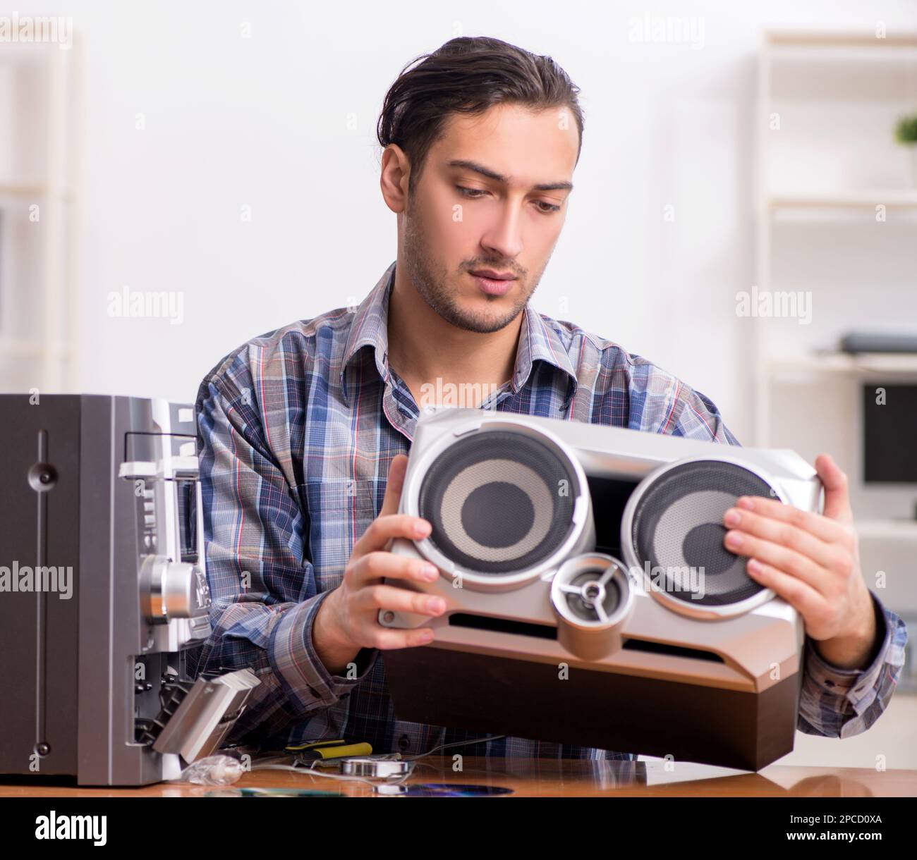 The young engineer repairing musical hi-fi system Stock Photo - Alamy