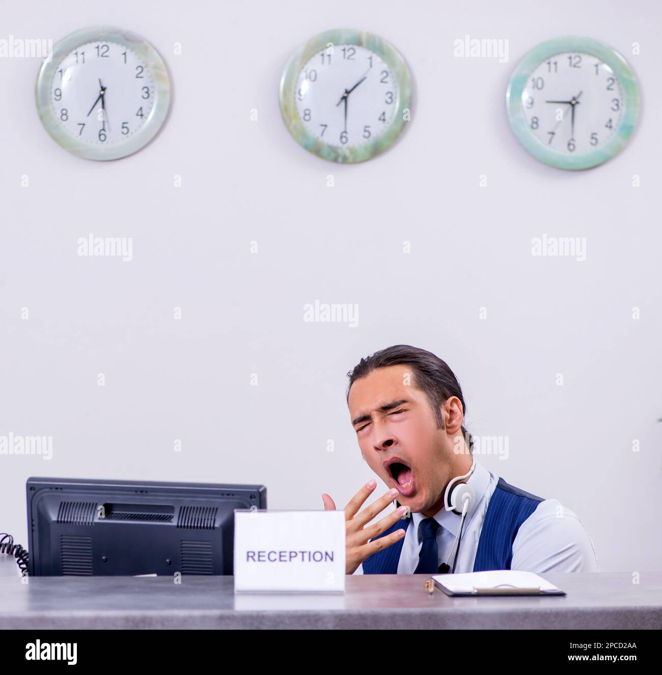The young man receptionist at the hotel counter Stock Photo - Alamy