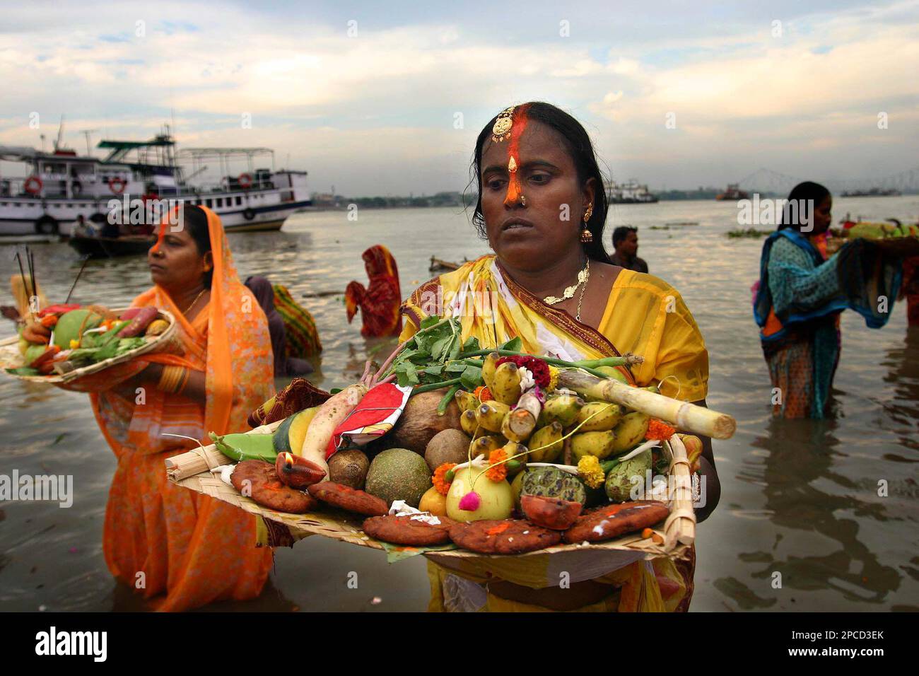 Hindu devotees worship the Sun God on the banks of the River Ganges on ...
