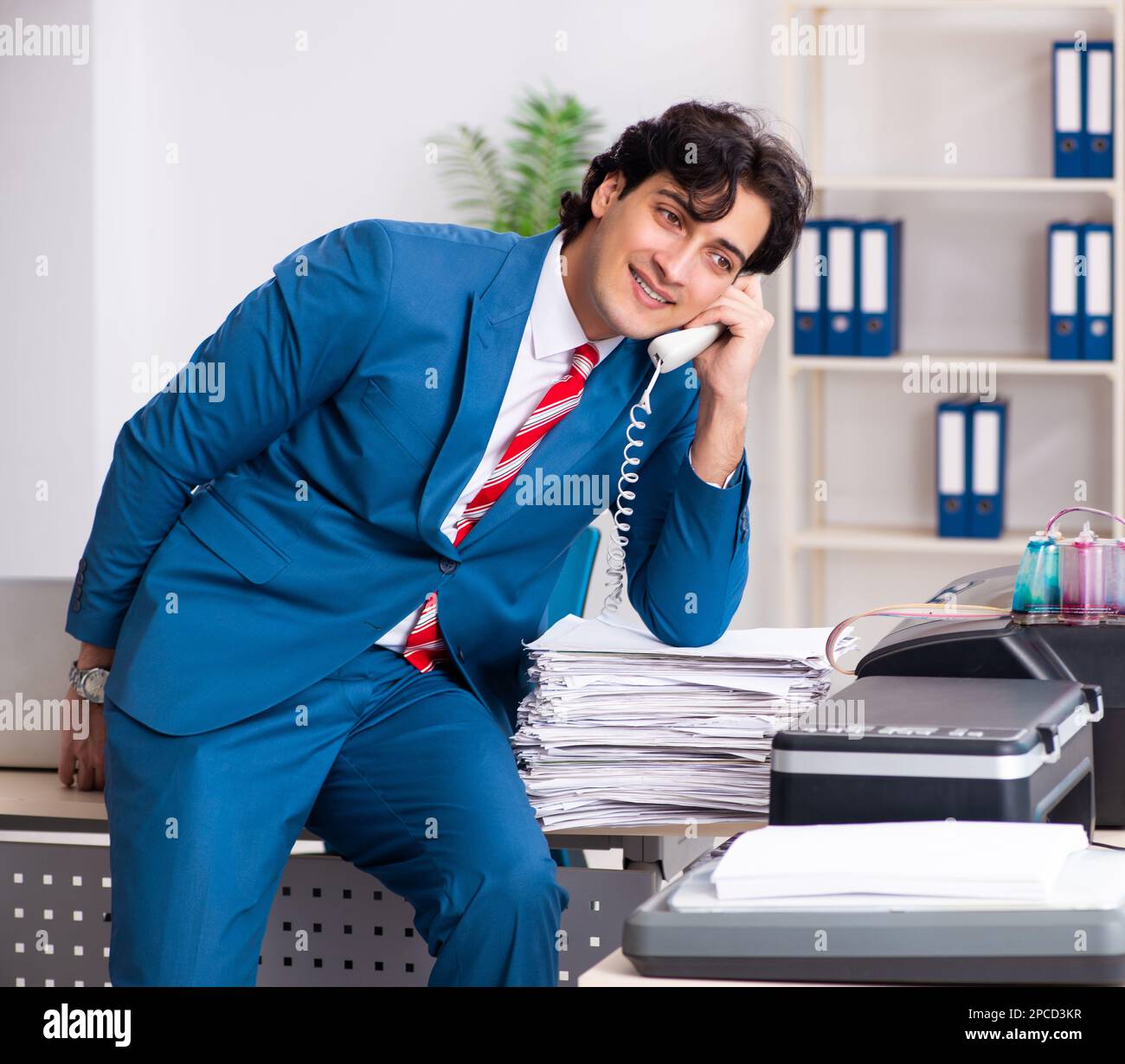 The young employee making copies at copying machine Stock Photo - Alamy