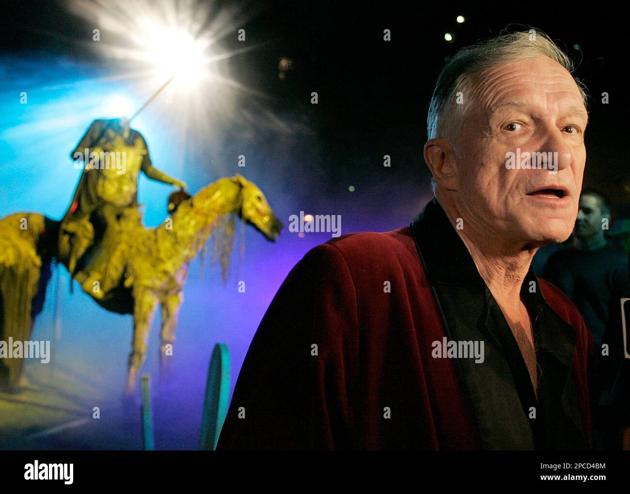 Playboy Founder Hugh Hefner speaks with a television news crew in front ...