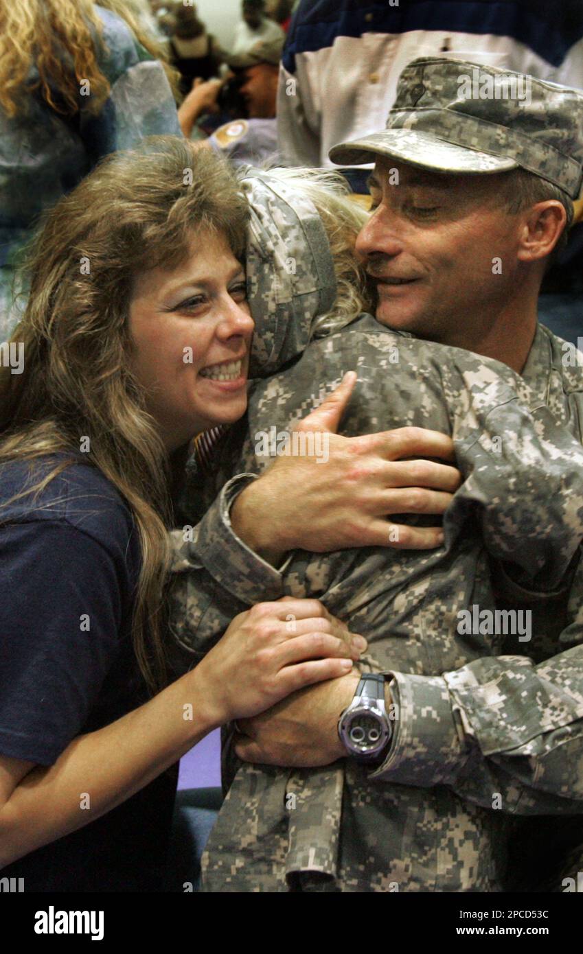 Jeff Berry, right, embraces his daughter, Cassie, and his wife , Mary ...
