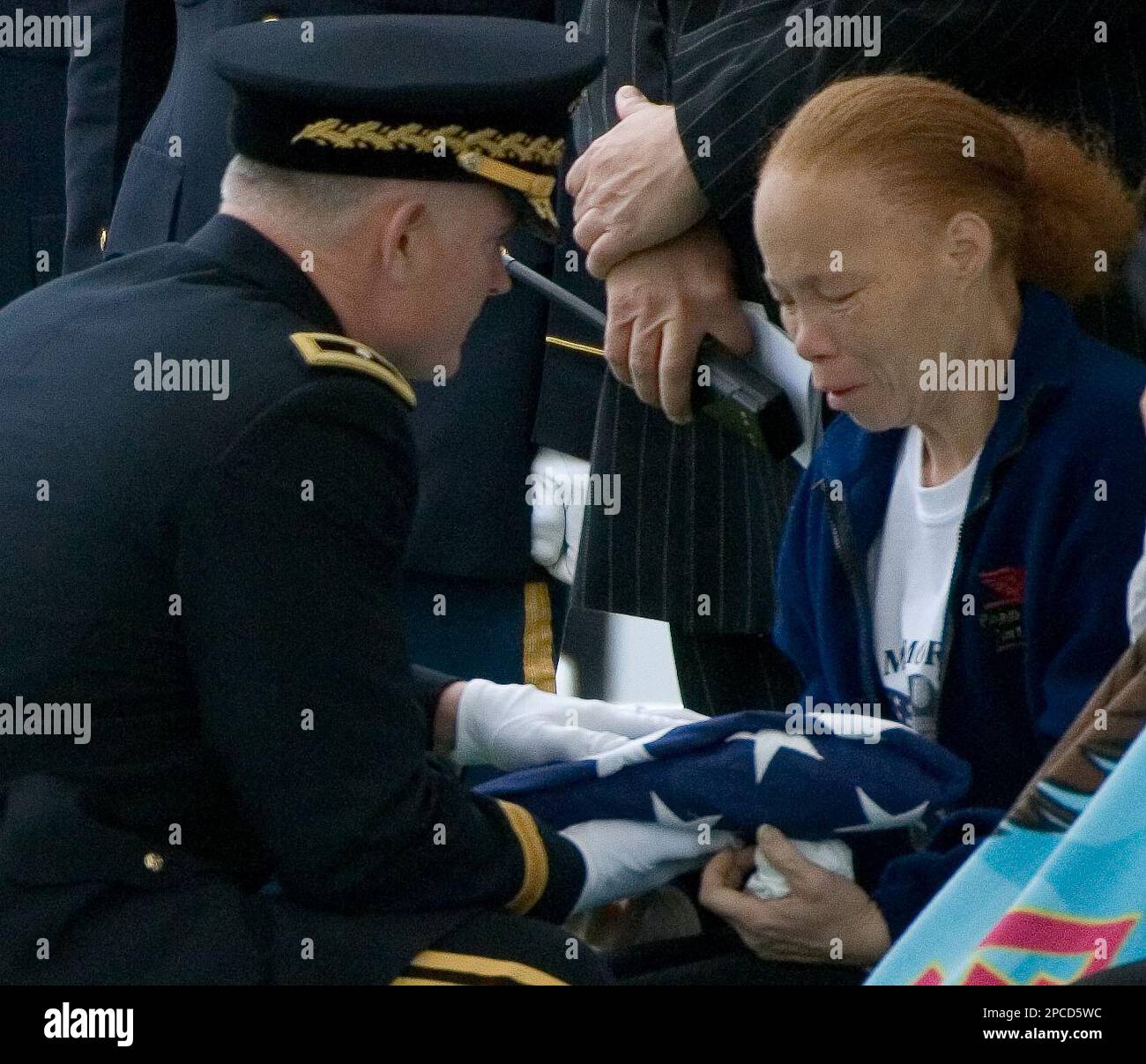 Brig. Gen. Charles Anderson, left, presents Peggy Crocker the flag that ...