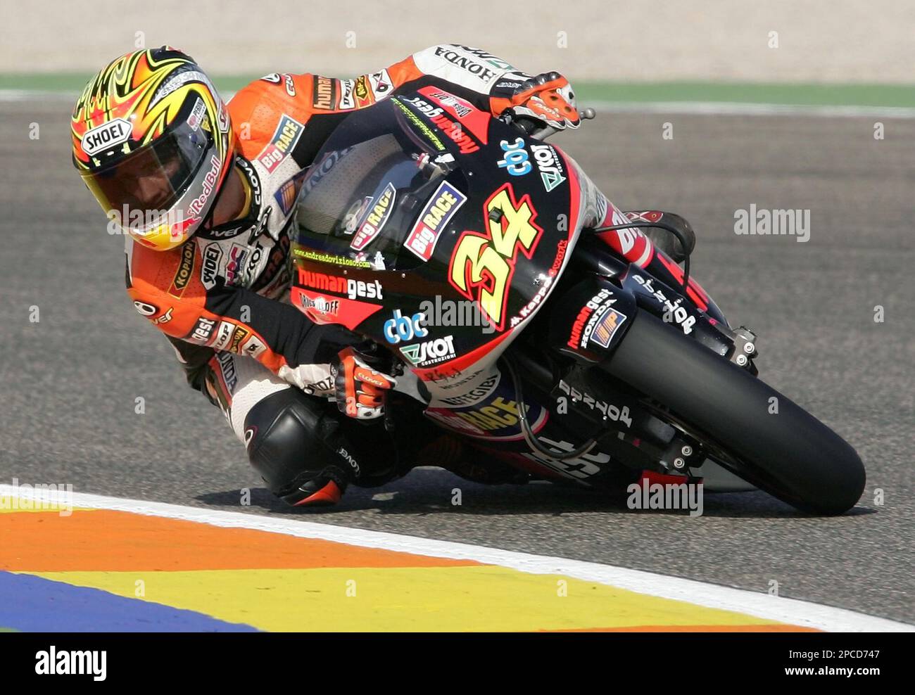 Italian 250cc rider Andrea Dovizioso takes a curve with his Honda ...