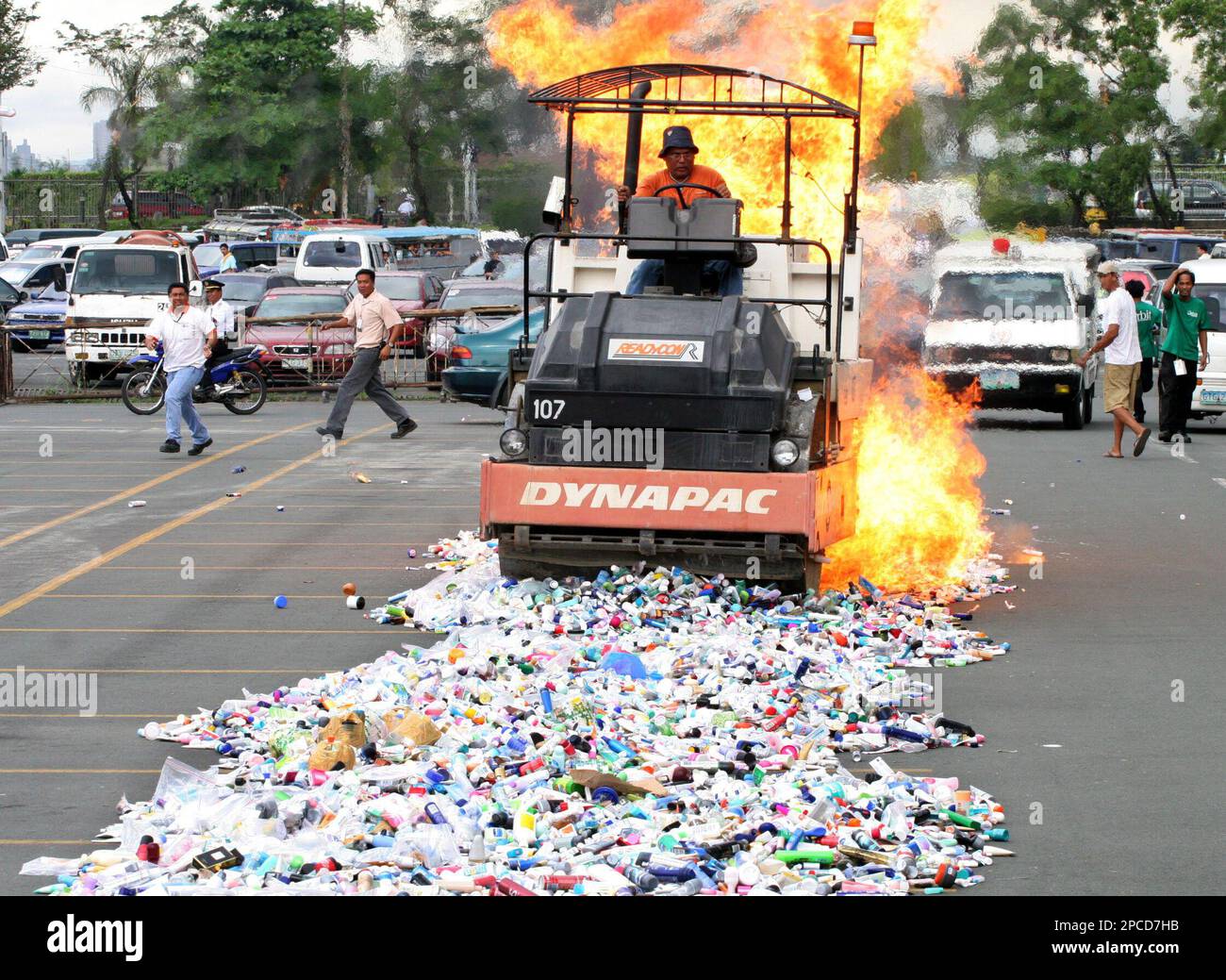 Fire almost engulfs a steamroller as it runs over thousands seized ...