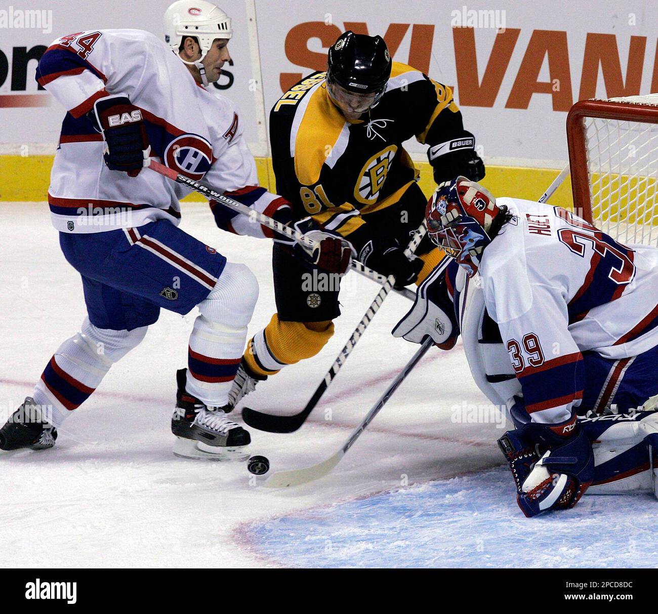 Boston Bruins' Phil Kessel, center, tries to control the puck against ...