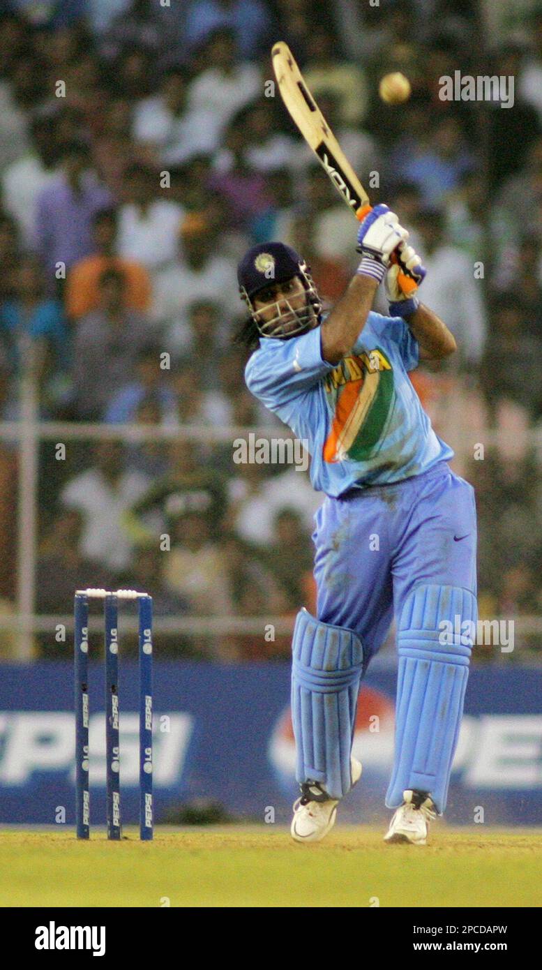 Indian Mahendra Singh Dhoni hits a shot during the match against West ...