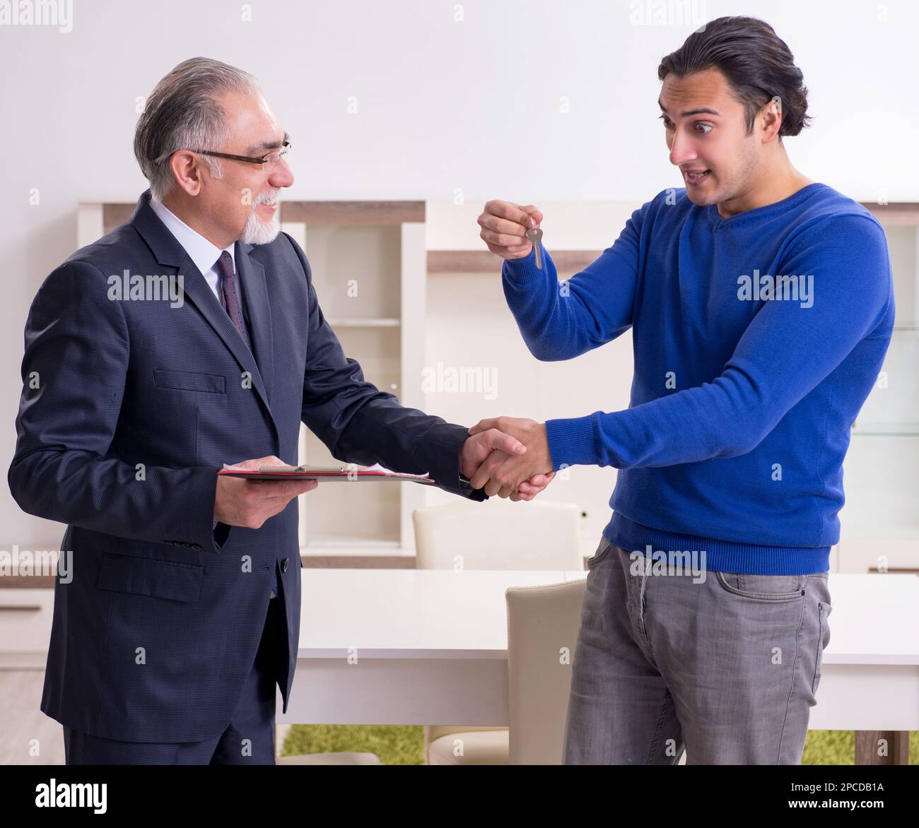 The male real estate agent and male client in the apartment Stock Photo ...