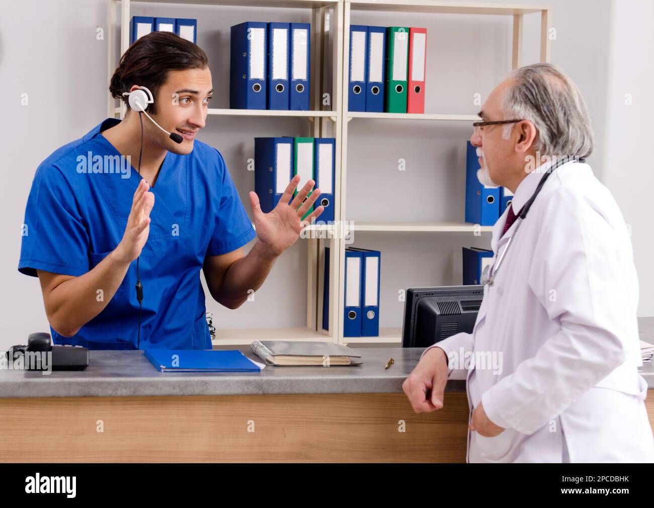 Doctors talking at the reception in hospital Stock Photo - Alamy