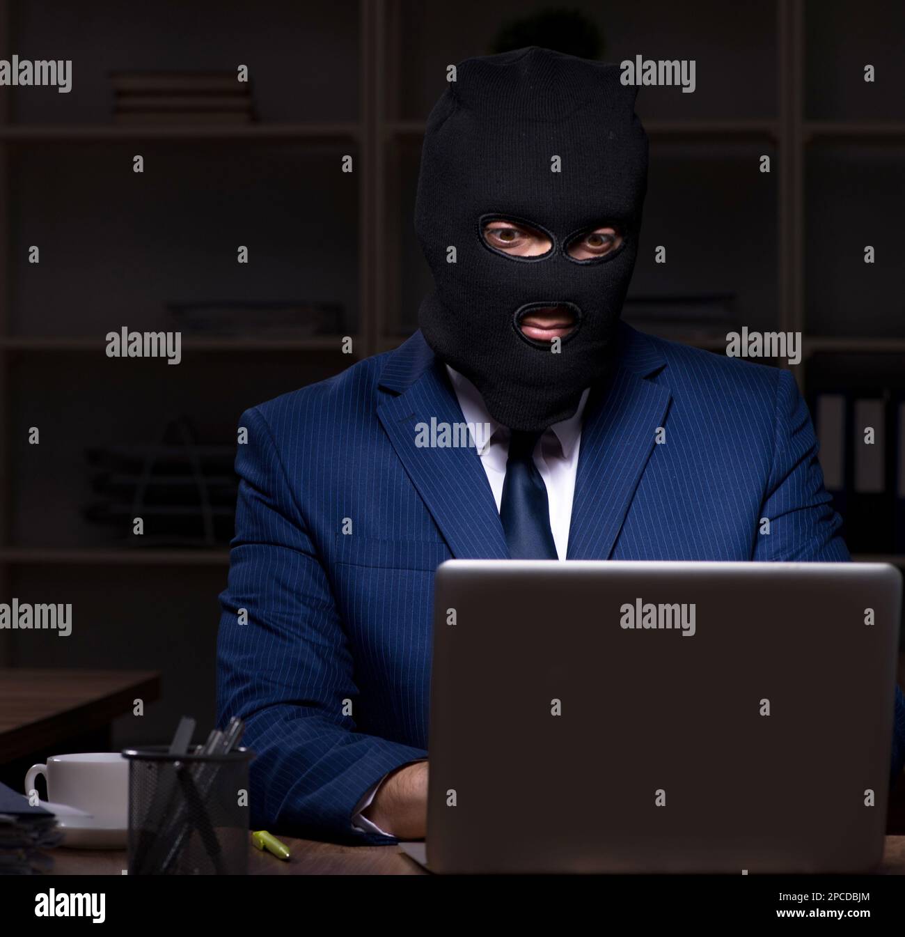 The male employee stealing information in the office night time Stock ...