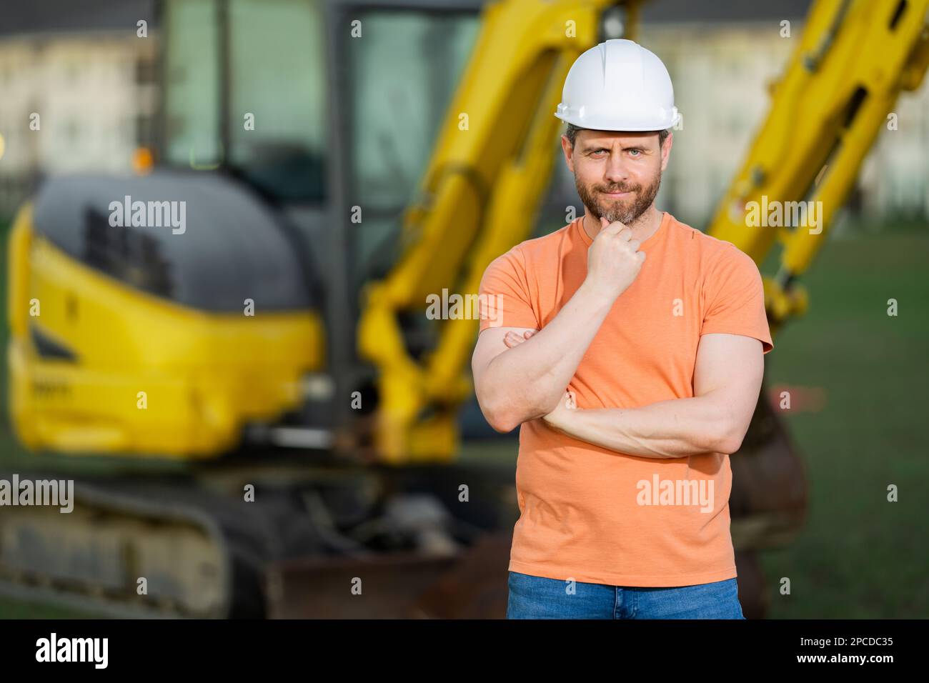 Builder in a construction site. Builder with excavator ready to build ...