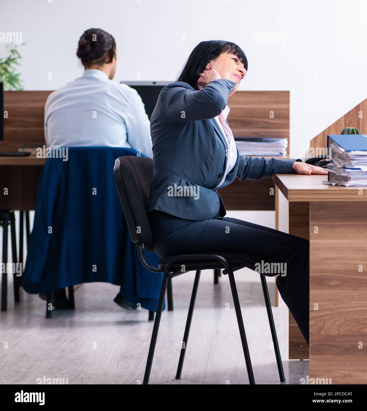 The two employees doing sport exercises in the office Stock Photo - Alamy