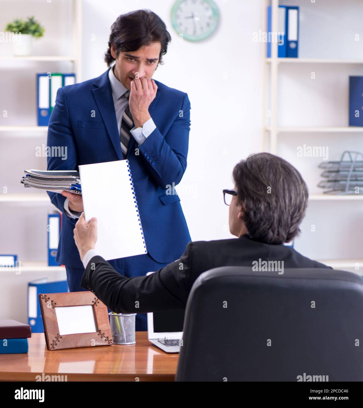 The boss and his male assistant working in the office Stock Photo - Alamy