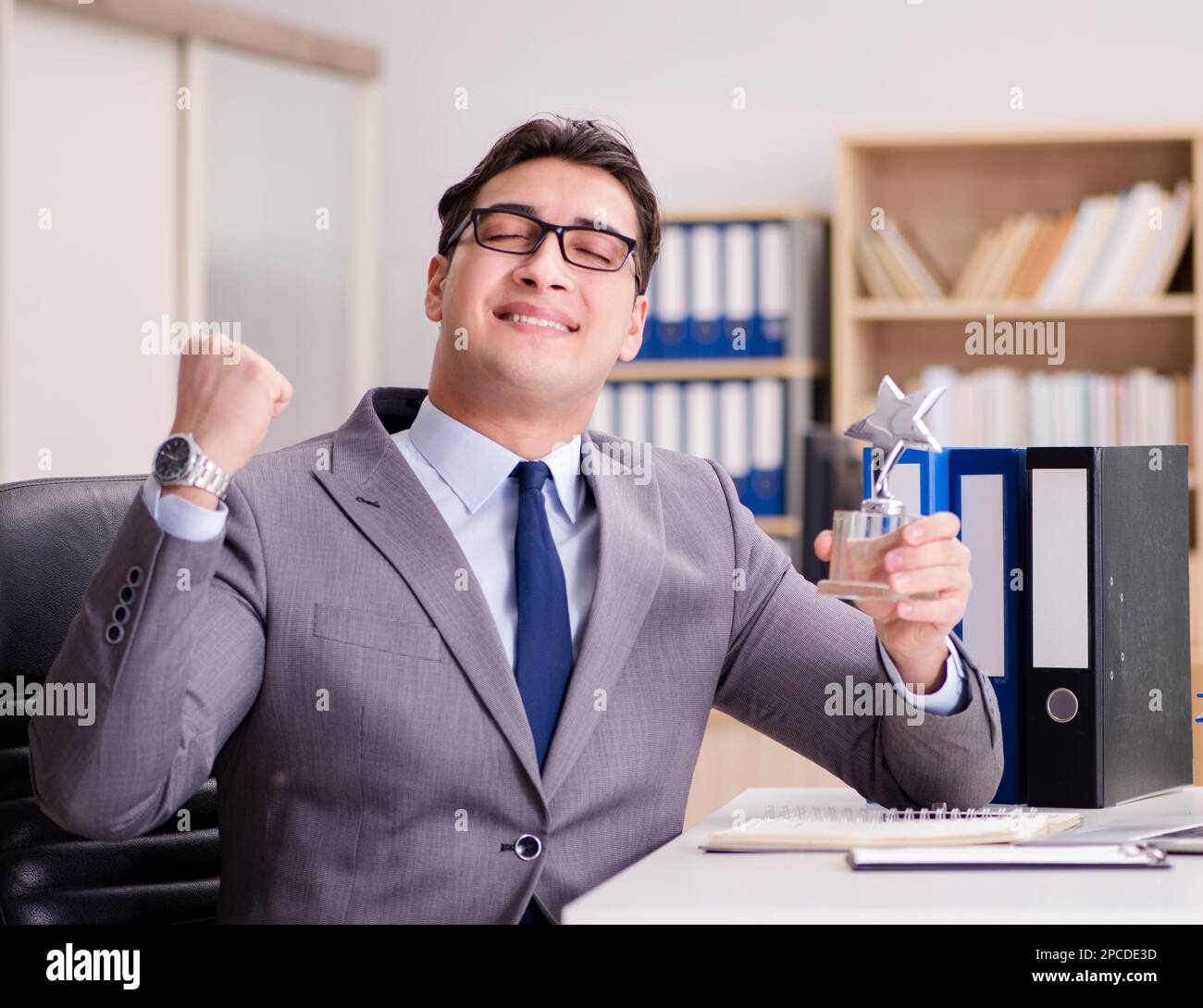 The businessman receiving award in the office Stock Photo - Alamy