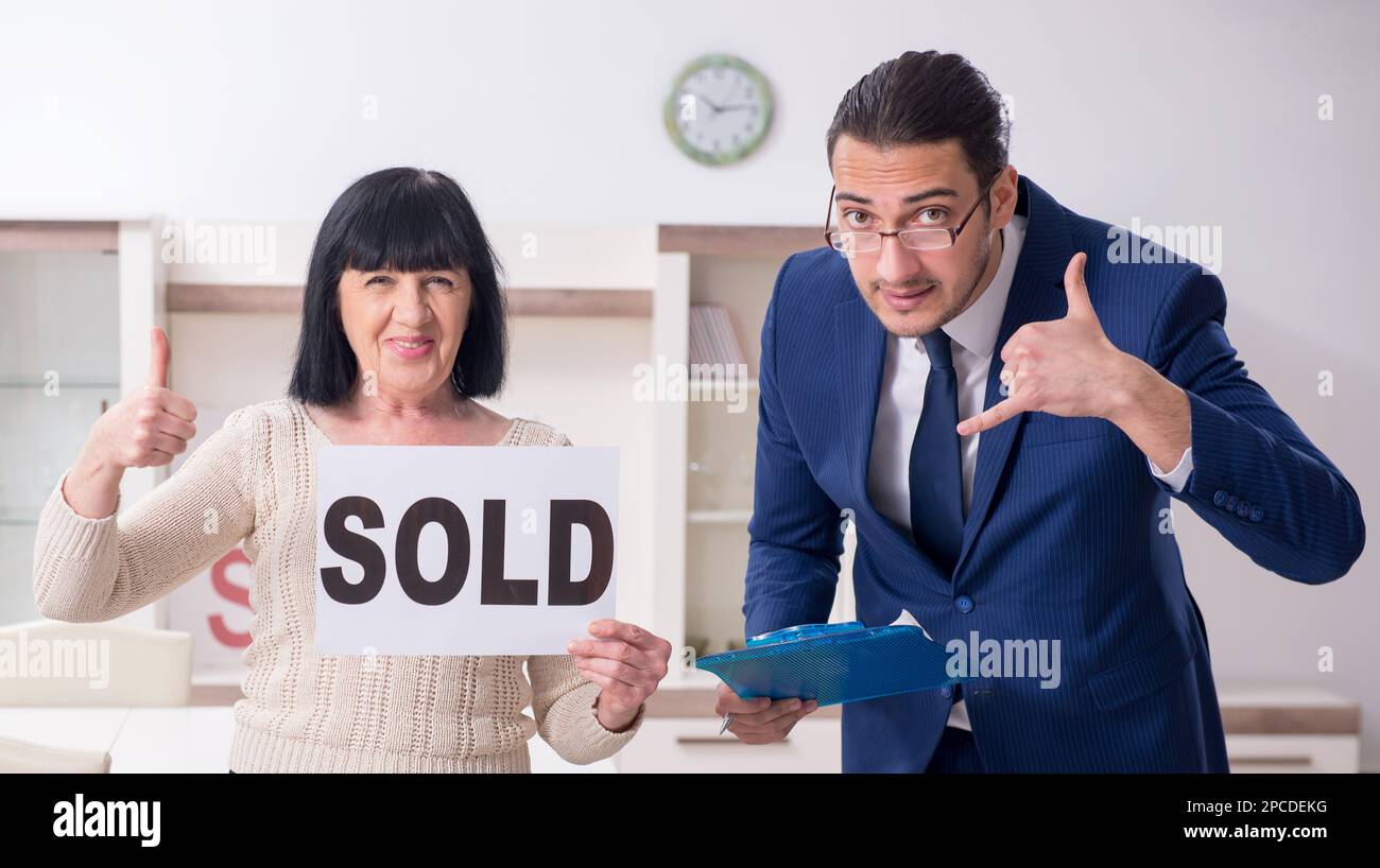 The male real estate agent and female client in the apartment Stock ...